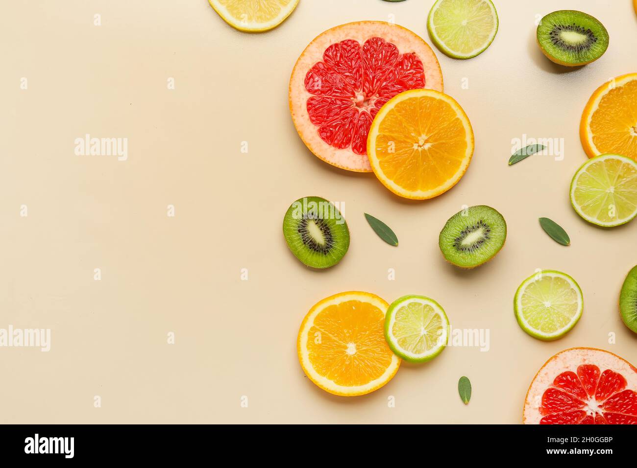 Slices of different fruits on color background Stock Photo - Alamy