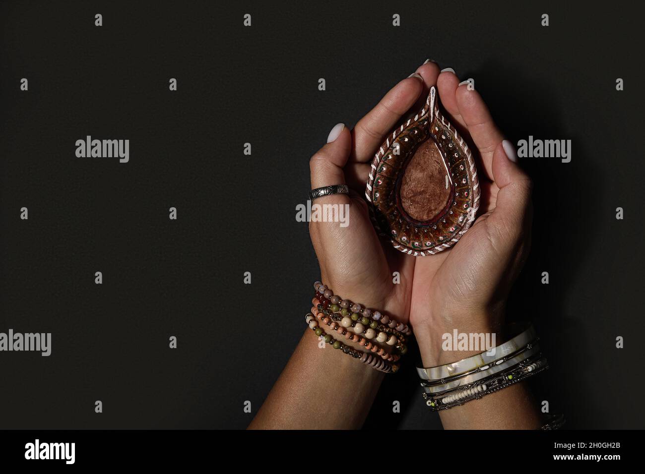 Female hands with diya lamp for Diwali on dark background Stock Photo ...