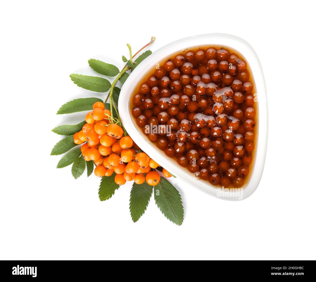 Bowl with delicious rowan jam and berries on white background Stock ...