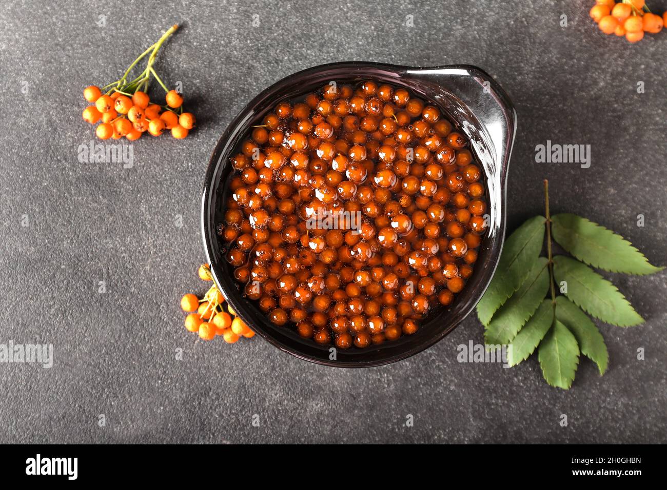 Bowl with tasty rowan jam on dark background Stock Photo - Alamy