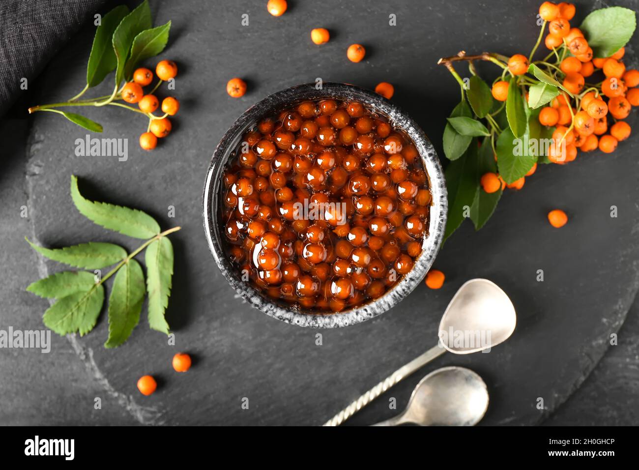 Bowl with healthy rowan berry jam on dark background Stock Photo - Alamy