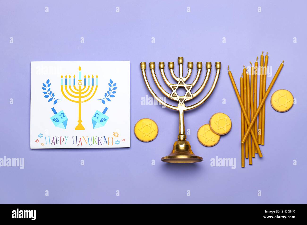 Different symbols of Hanukkah and greeting card on color background ...