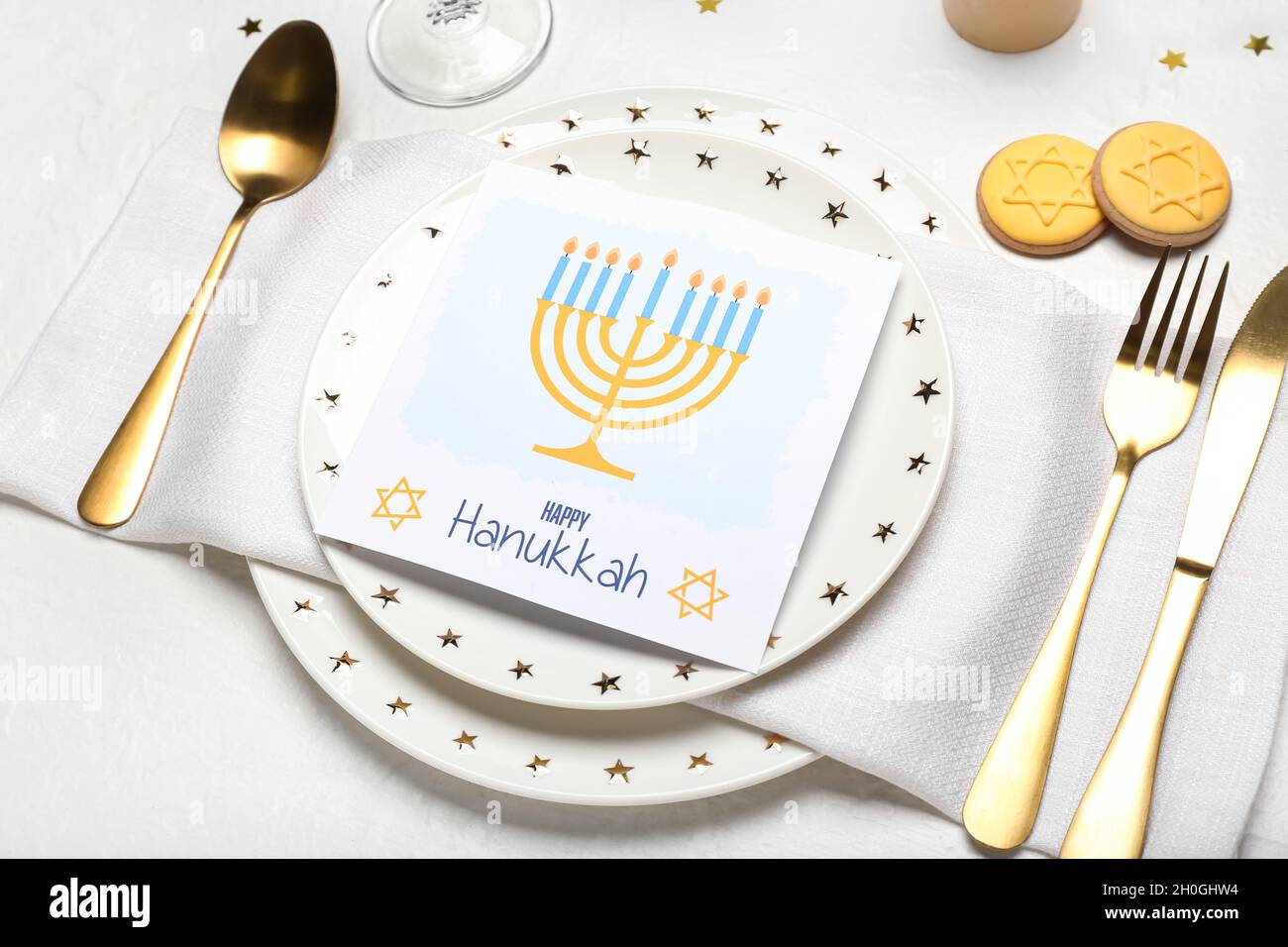 Table setting for Hanukkah celebration on white background Stock Photo ...
