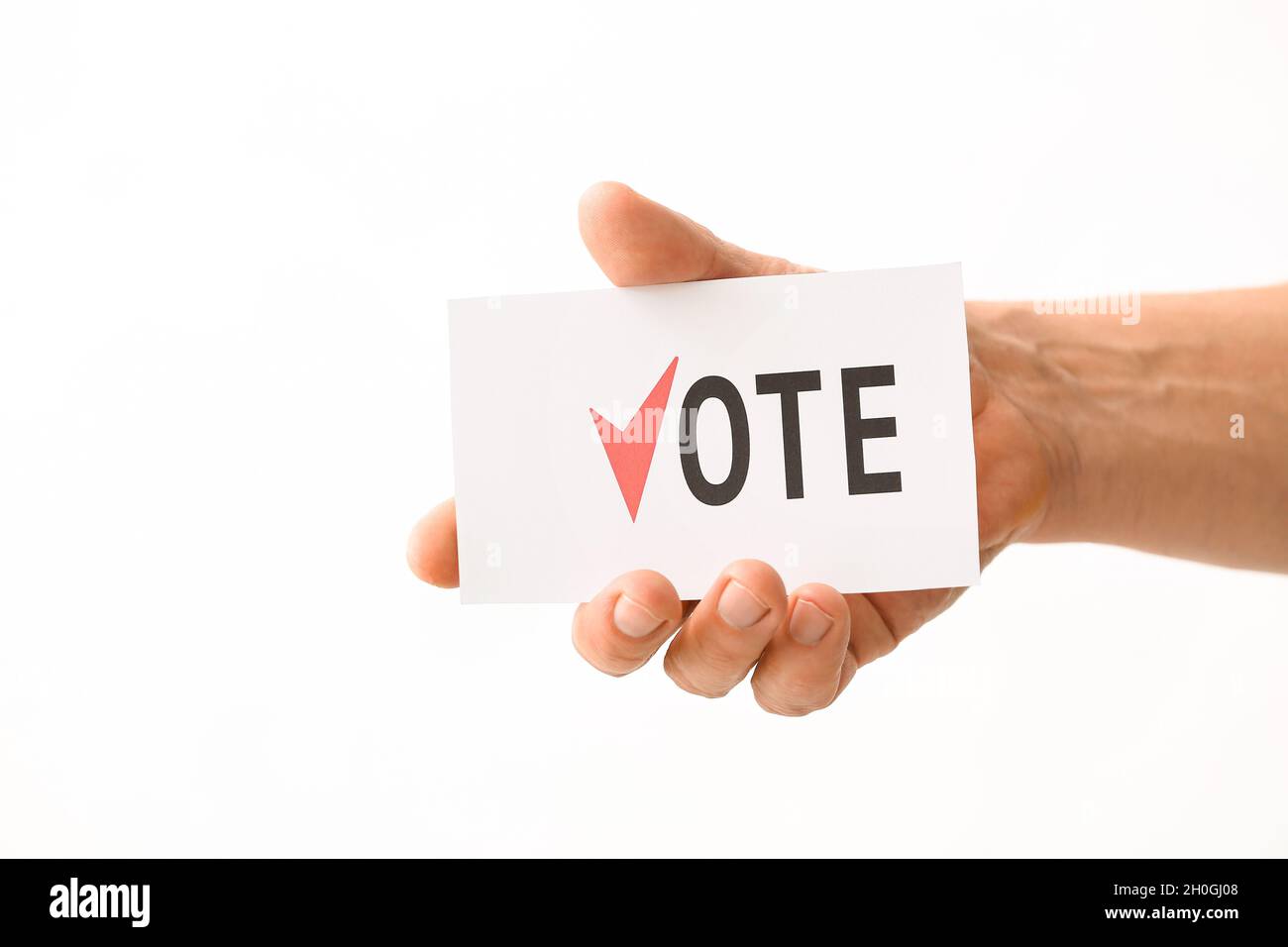 Hand holding paper with text VOTE on white background Stock Photo - Alamy