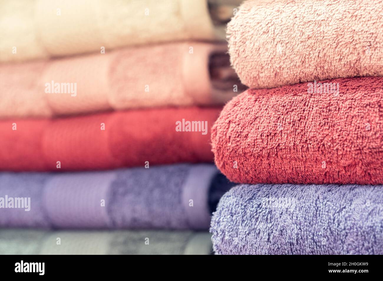 Colorful folded towels stack closeup picture Stock Photo - Alamy