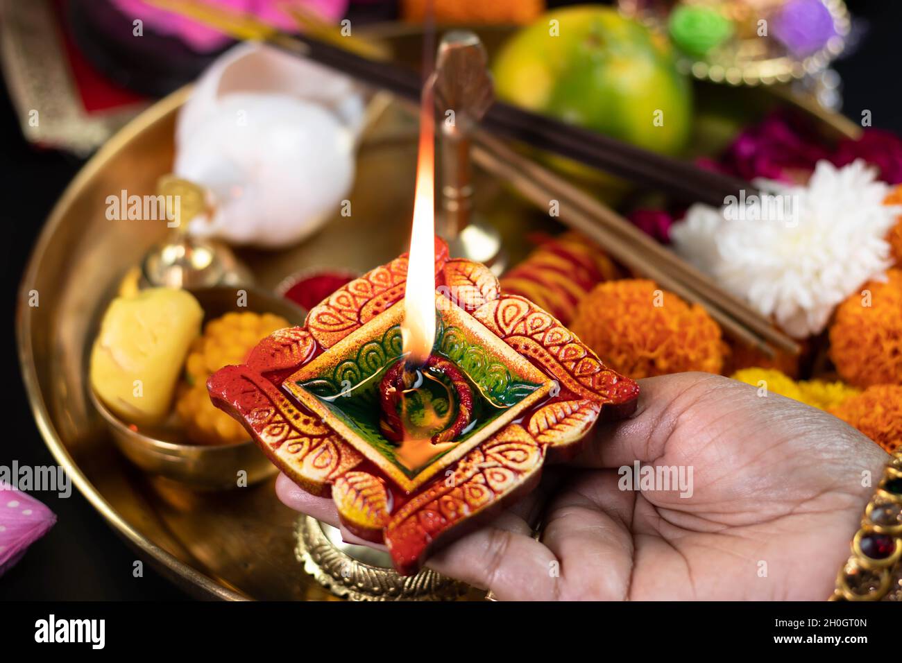 Hand holding diya hi-res stock photography and images - Alamy