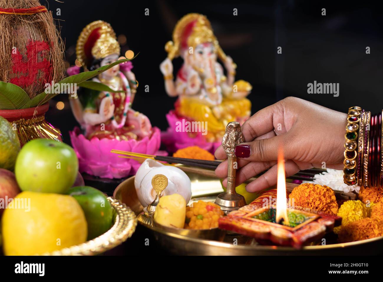 Hands Of Girl Holding Ghanti Bell. Clay Diya Deep Dia Lamp Illuminated ...