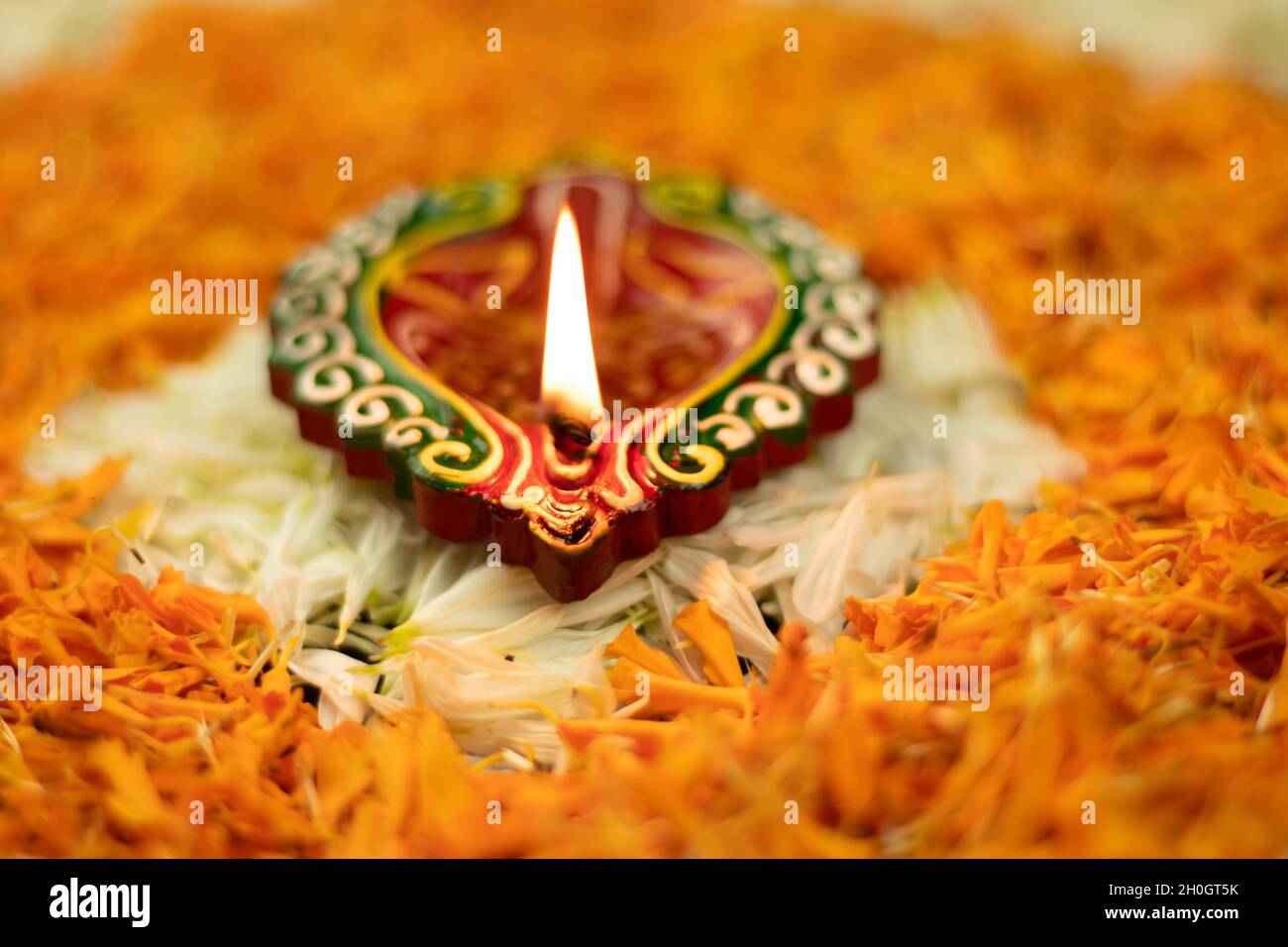 Handcrafted Clay Diya Lit On Floral Rangoli Made Of Marigold Flowers ...