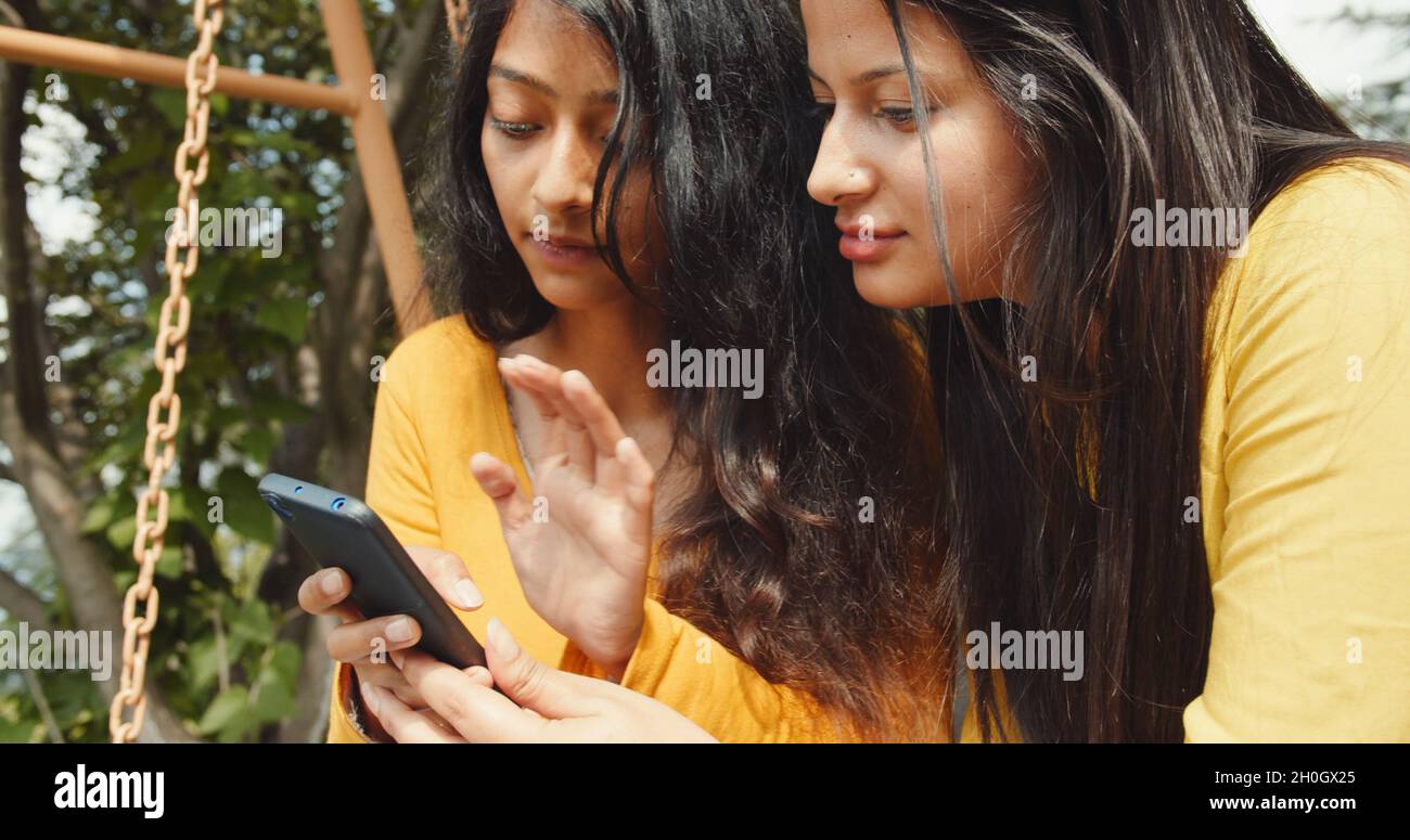 Indian girls hanging out together are scrolling on the smartphone Stock ...
