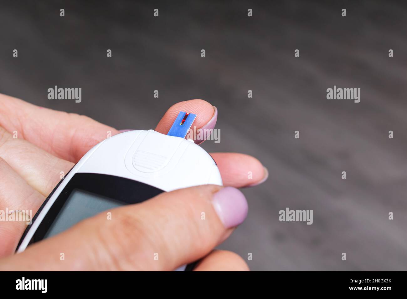 Female hands and glucometer measuring blood sugar close up Stock Photo ...