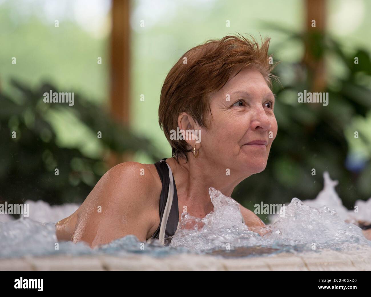 Elderly woman enjoying in pool with hot water in spa resort Stock Photo ...