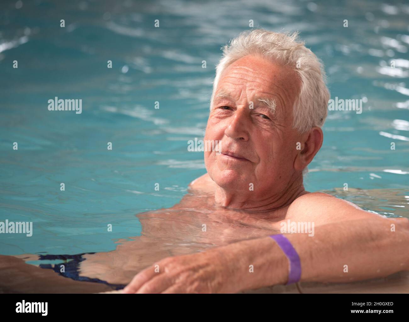 Elderly man enjoying in pool with hot water in spa resort Stock Photo ...