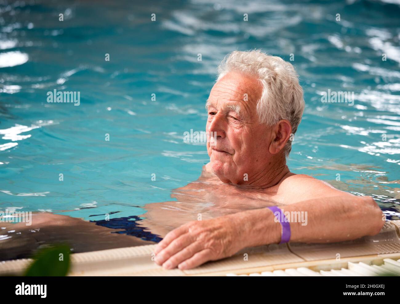 Elderly man enjoying in pool with hot water in spa resort Stock Photo ...