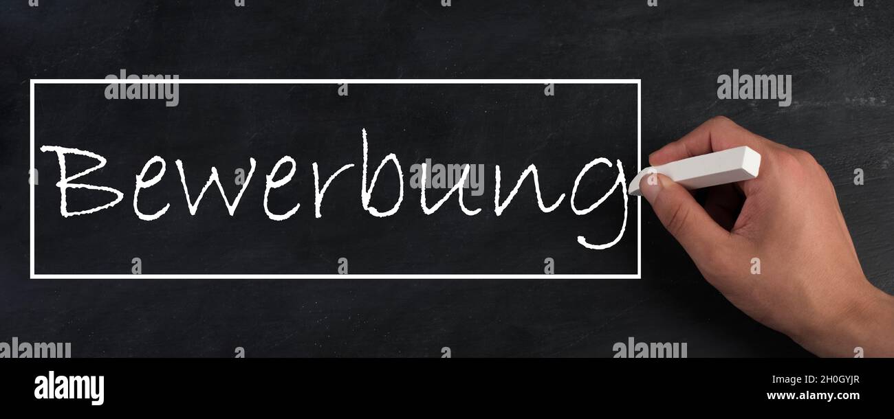 : The word application is standing in german language on a chalkboard ...