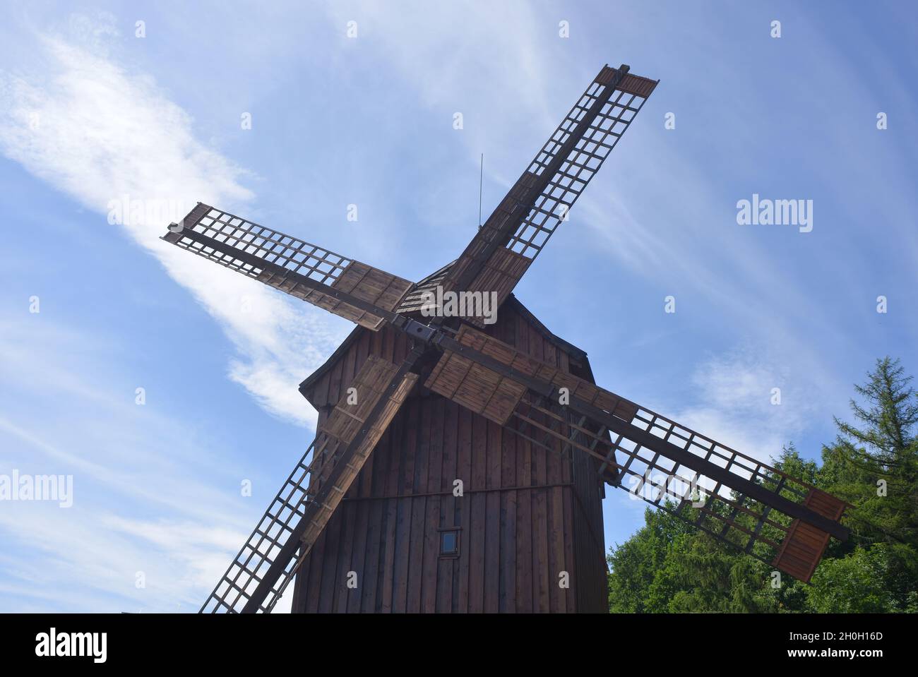 Wooden windmill in the landscape Stock Photo - Alamy