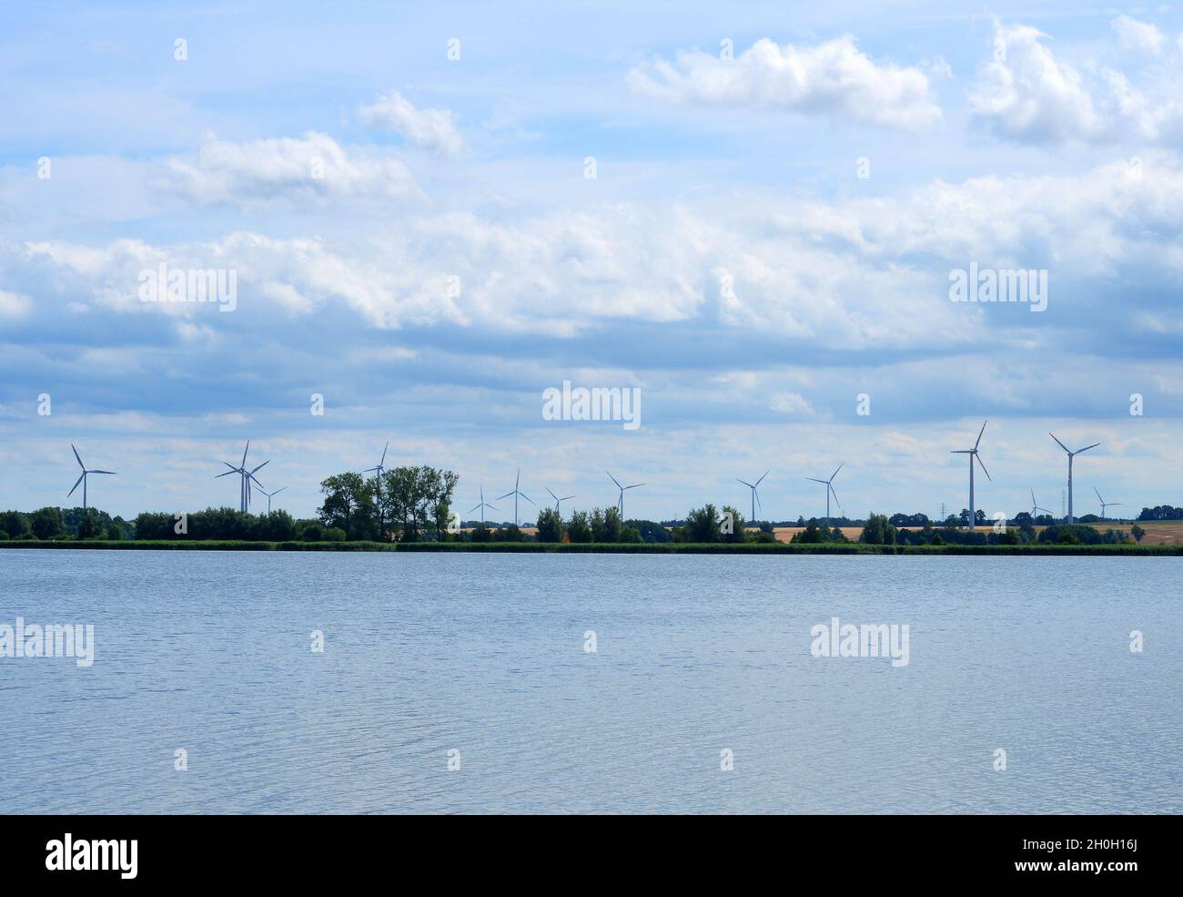 Wind power, landscape and a lake and cloudy weather Stock Photo - Alamy