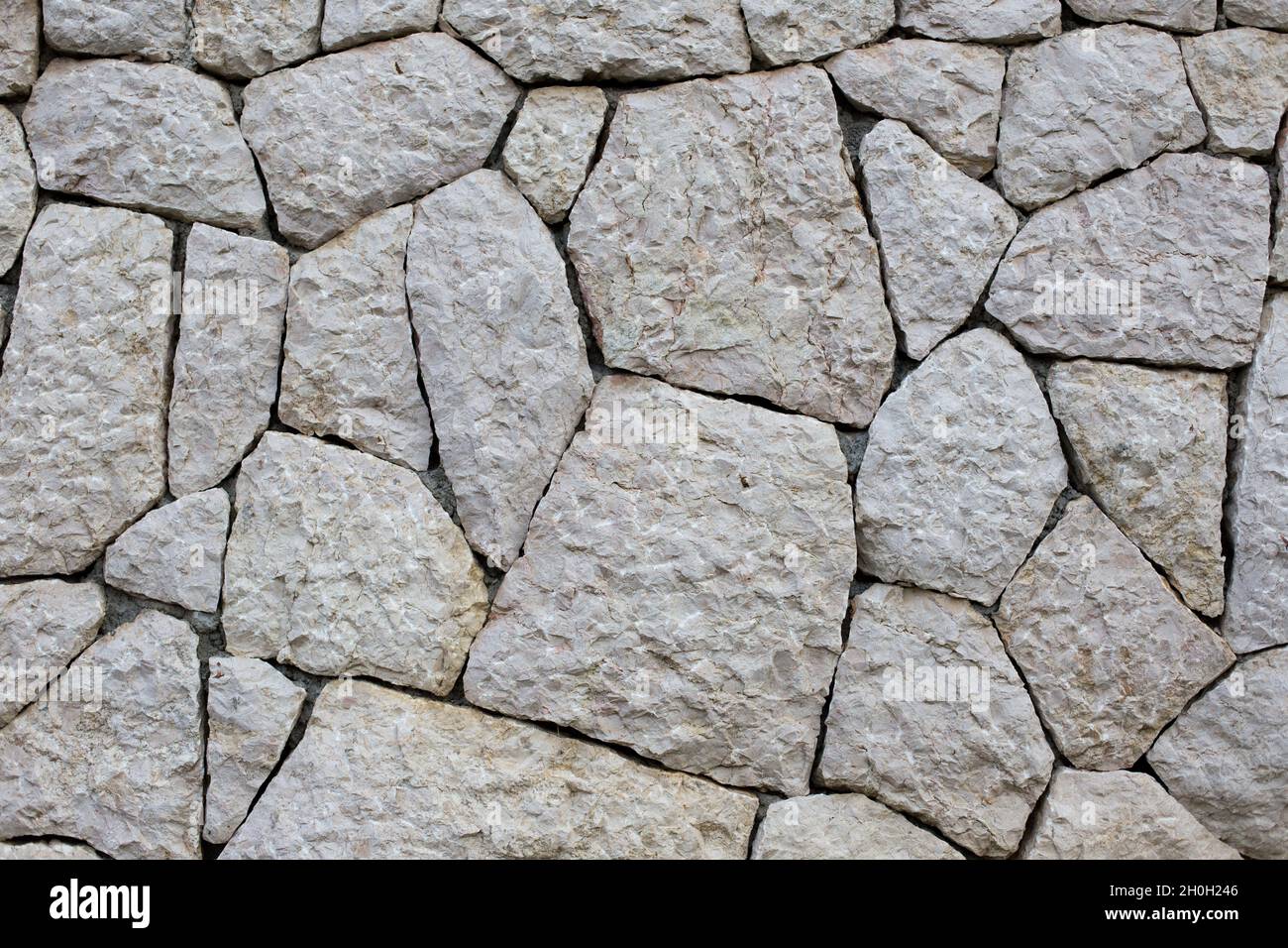 Stone wall texture made of irregular shapes of white material Stock ...