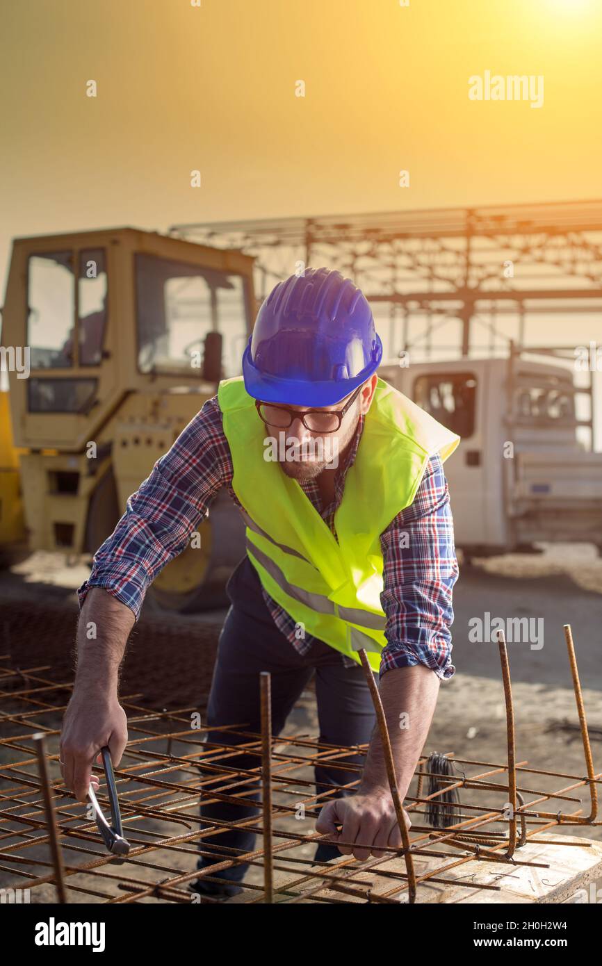 Young attractive construction worker with helmet working on ...