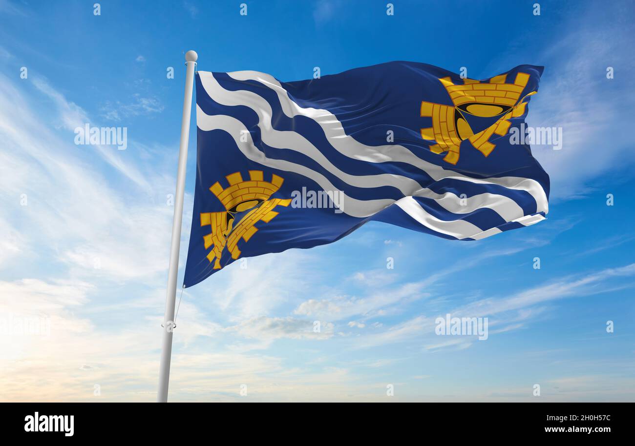 flag of county Merseyside, UK at cloudy sky background on sunset ...