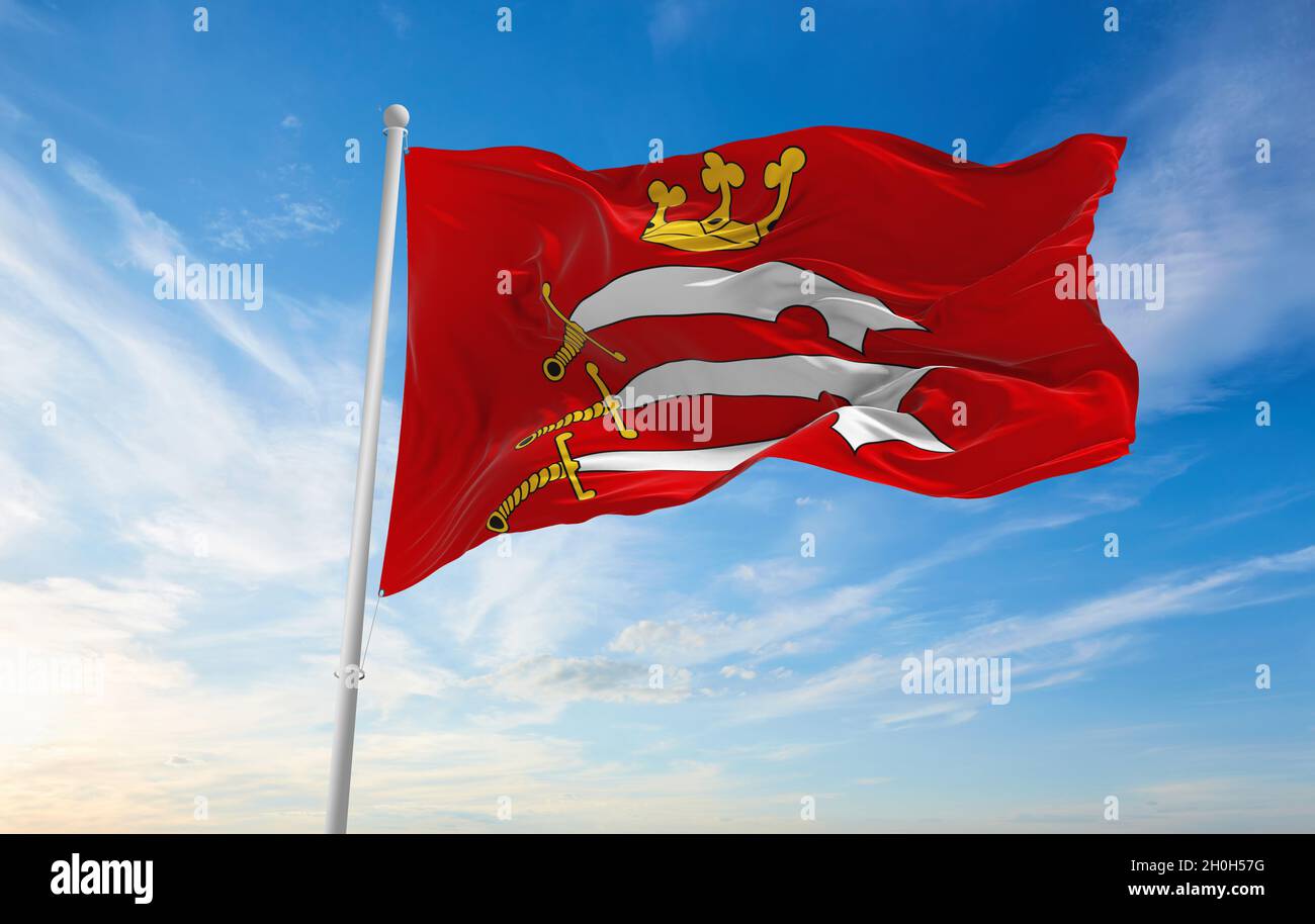 flag of county Middlesex, UK at cloudy sky background on sunset ...