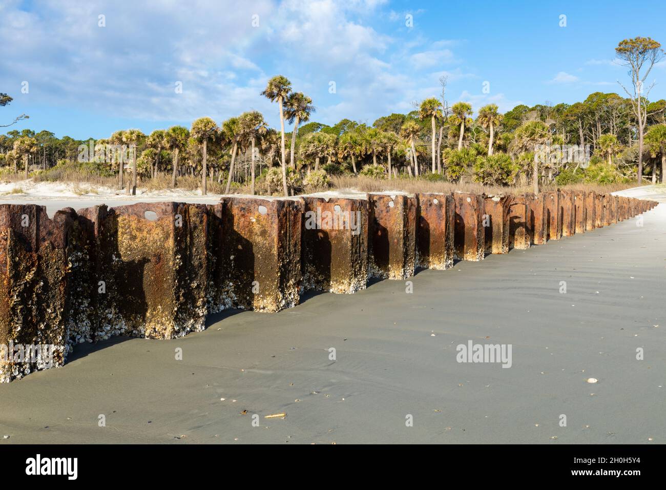 View looking inland of a corrugated metal erosion wall, rusty and ...