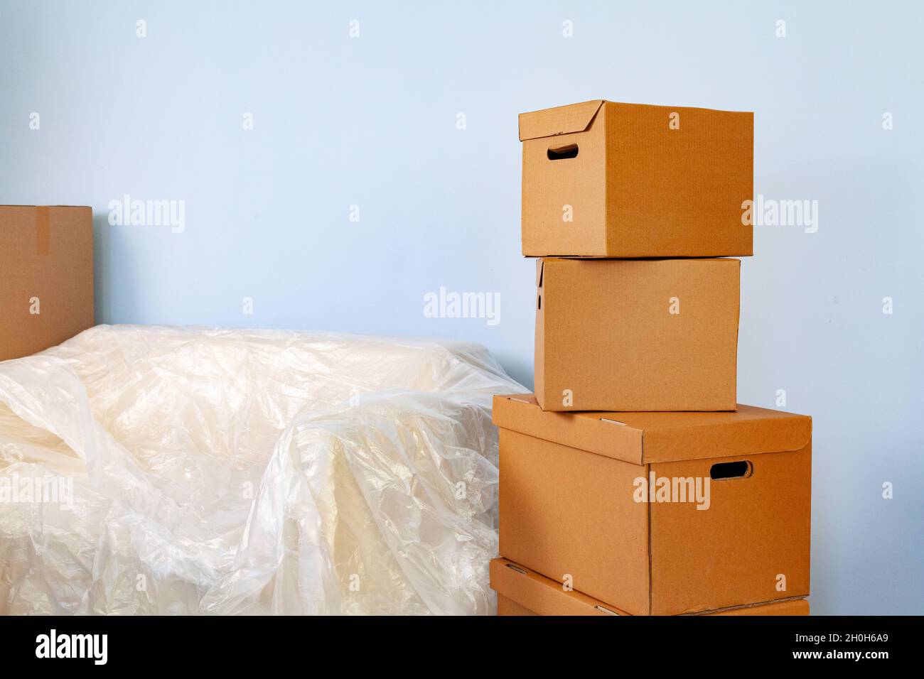 Packed household stuff in boxes and packed sofa for moving Stock Photo ...