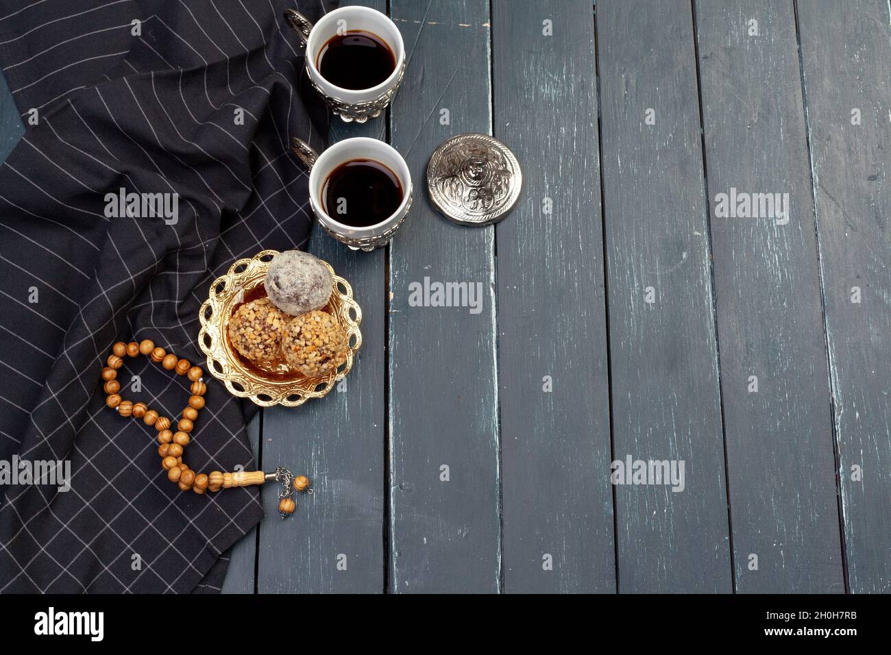 Nut balls dessert served with coffee on dark wooden table, top view ...
