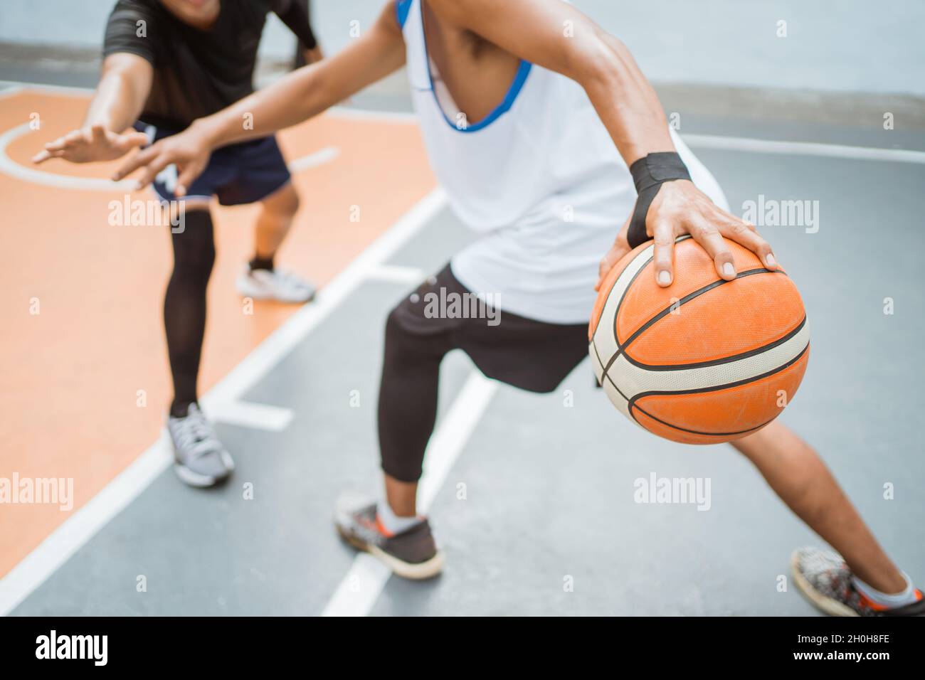 Basketball player's hand carrying a ball with a high dribbling ...