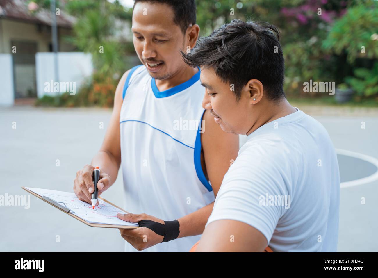 a basketball coach explains tactics and gives instructions to a player ...