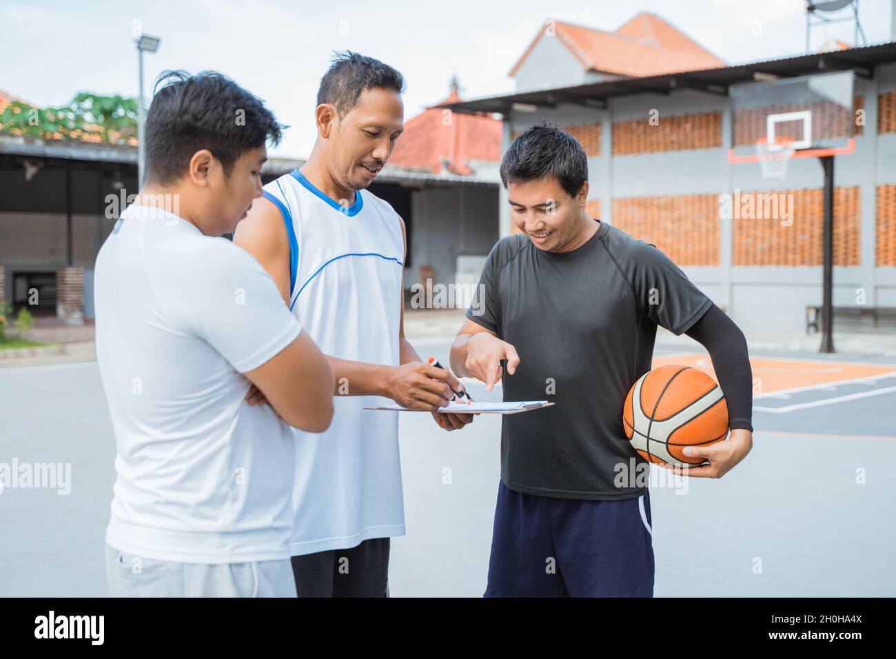 a basketball coach explains tactics and gives instructions to a player ...
