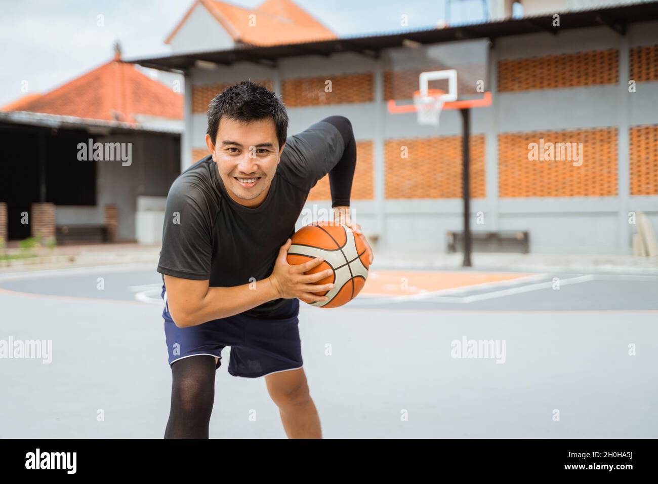 a basketball player holding a basketball in a pose holding the ball ...