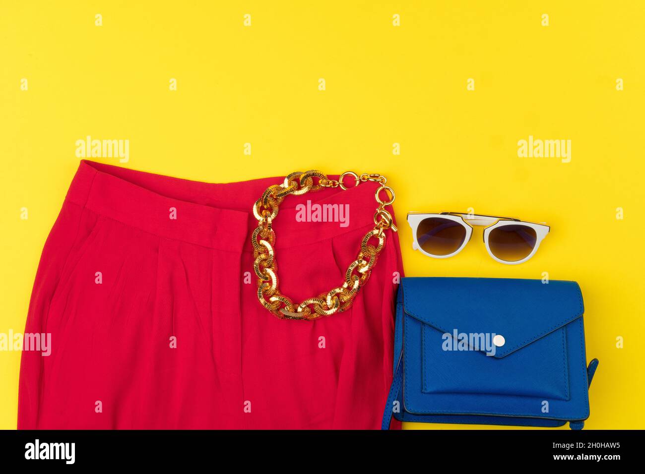 Trendy woman outfit with accessories on bright yellow background Stock ...