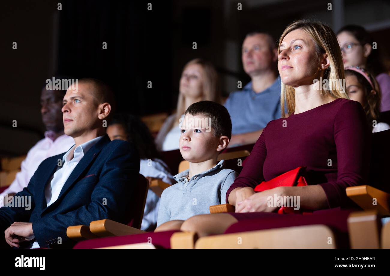 Family with son watching spectacle in theater Stock Photo - Alamy