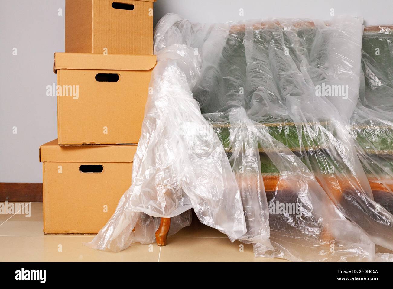 Packed household stuff in boxes and packed sofa for moving Stock Photo ...