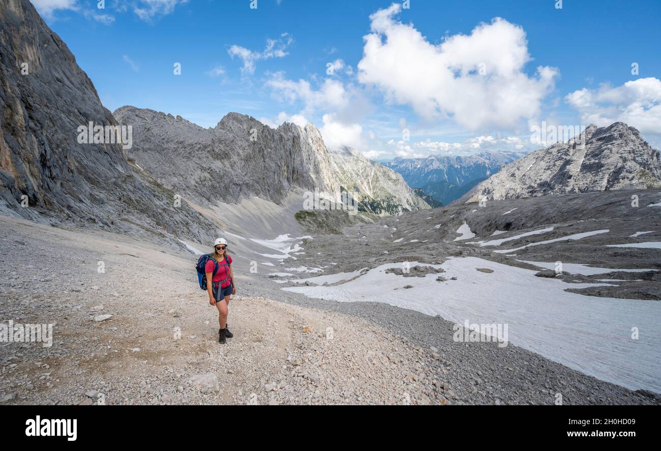 Hiker crossing a scree field, hiking to the Patenkirchner Dreitorspitze ...