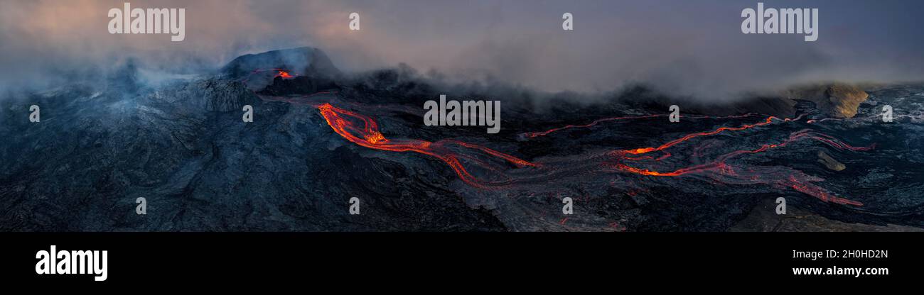 Aerial view, erupting volcano with lava fountains and lava field ...