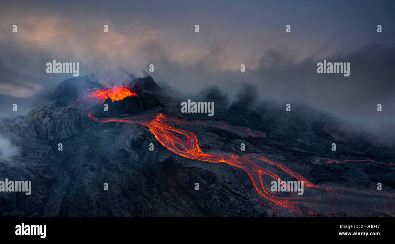 Aerial view, erupting volcano with lava fountains and lava field ...