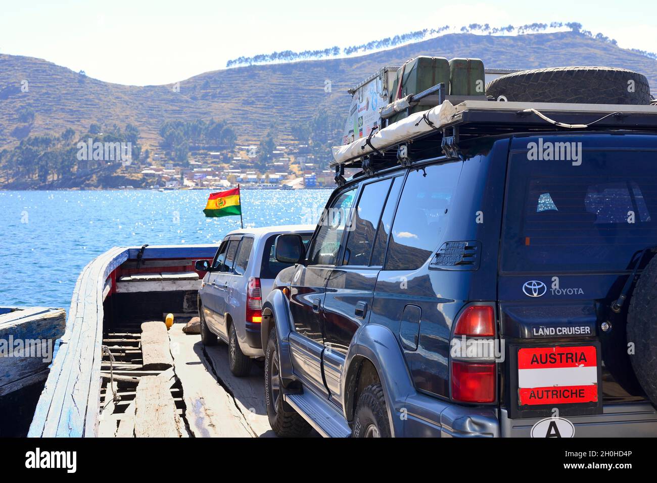 Austrian off-road vehicle on a simple ferry boat across the Strait of ...