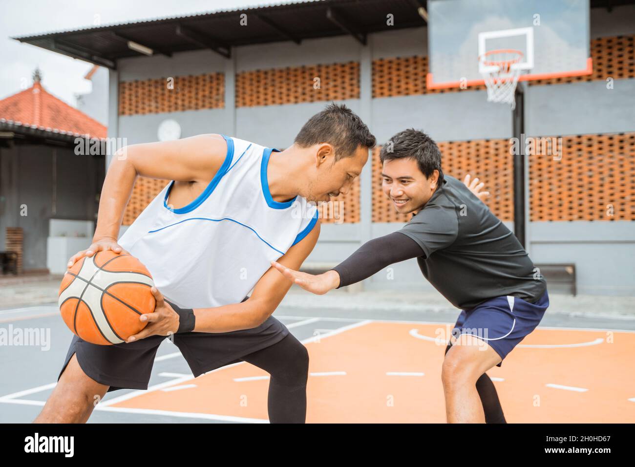 basketball player dribble the ball face to face with opposing player ...