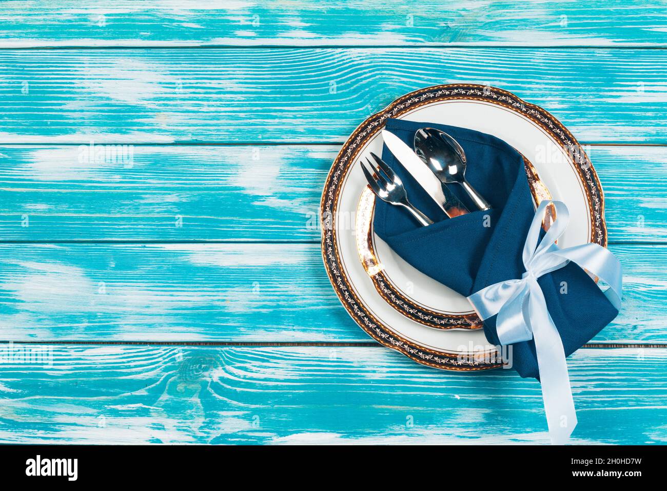 Beautiful table setting on blue wooden background Stock Photo - Alamy