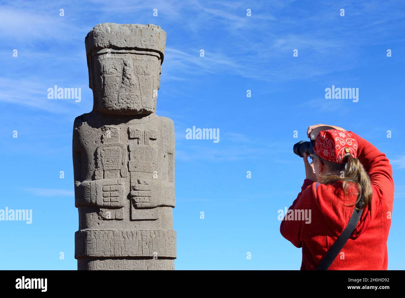Woman photographing the Ponce Monolith, pre-Inca ruins of Tiwanaku ...