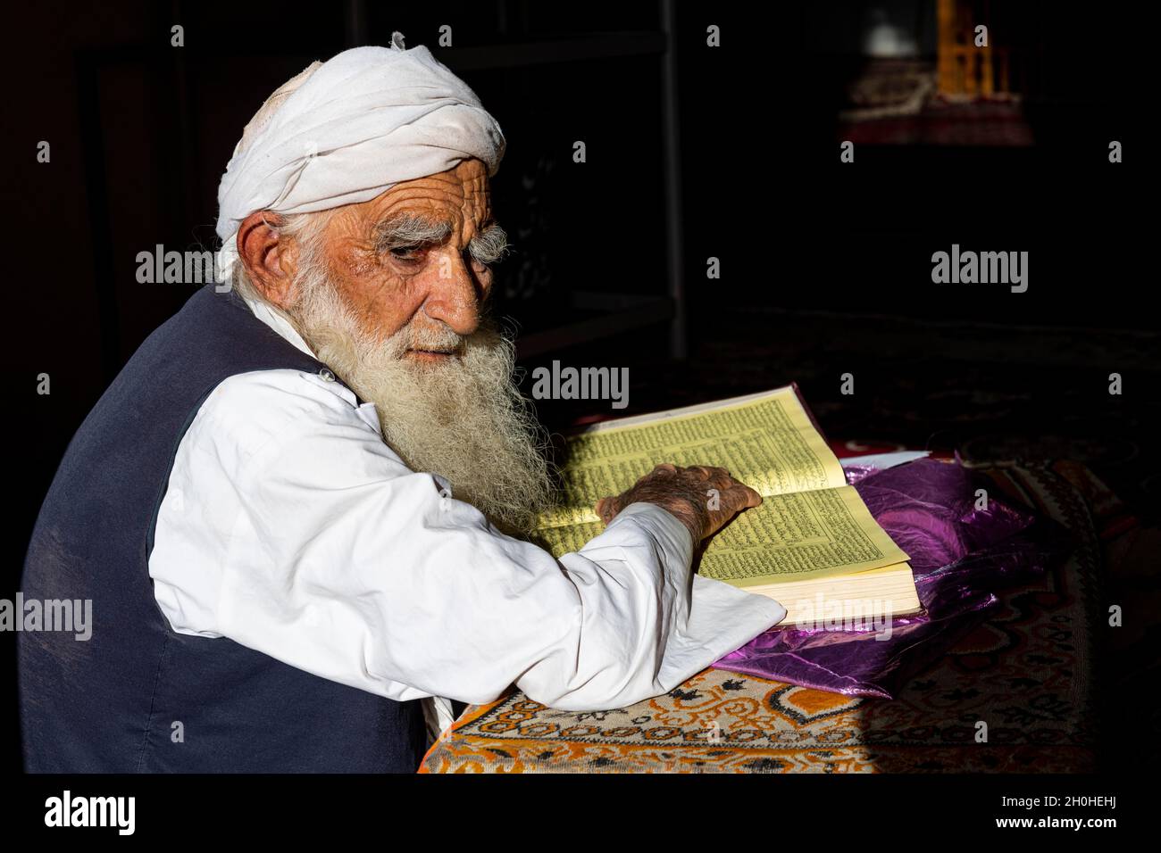 Sufi priest studying the holy Quran in the Shrine of Mawlana Abdur ...