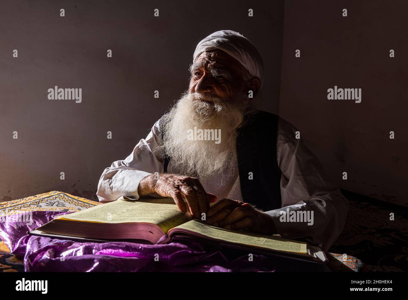 Sufi priest studying the holy Quran in the Shrine of Mawlana Abdur ...