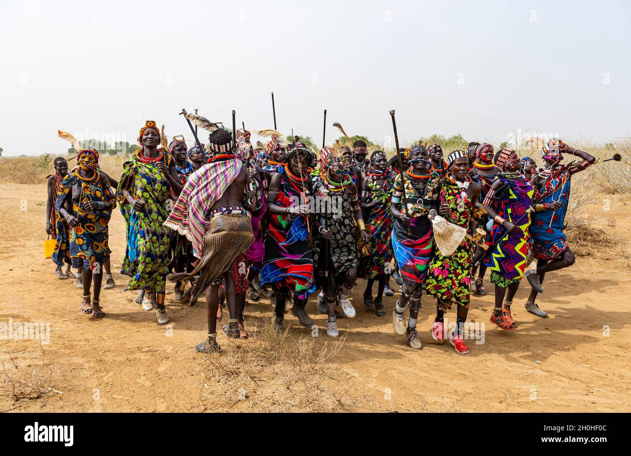 Traditional dressed women of the Jiye tribe dancing and singing ...