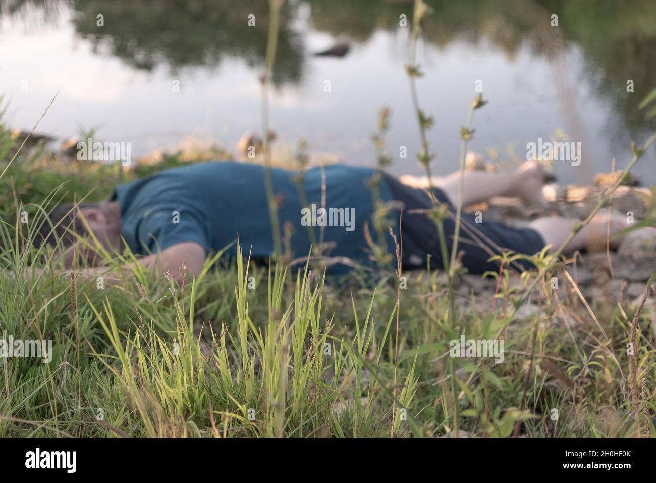 the corpse of a dead man lies on the shore by the water.artistic photo ...