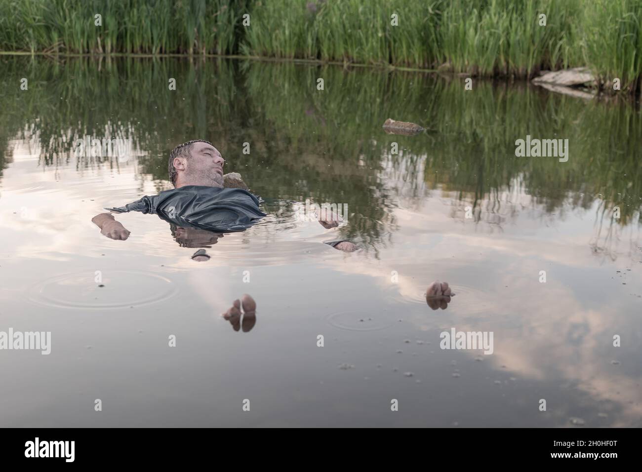 the body of a man who drowned lies face up in the water, the lifeless ...