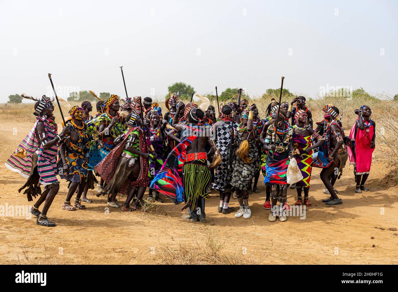 Traditional dressed women of the Jiye tribe dancing and singing ...