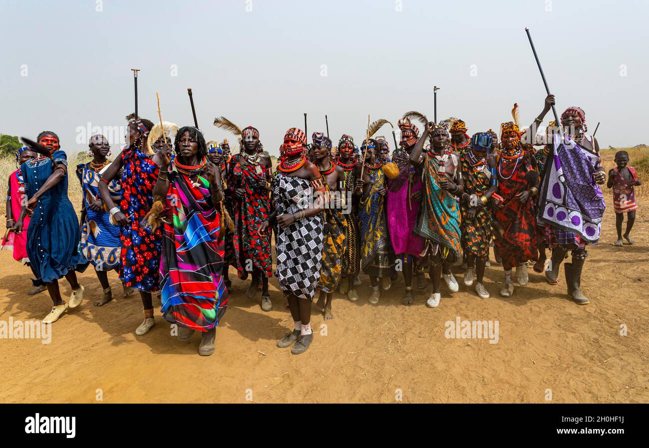 Traditional dressed women of the Jiye tribe dancing and singing ...