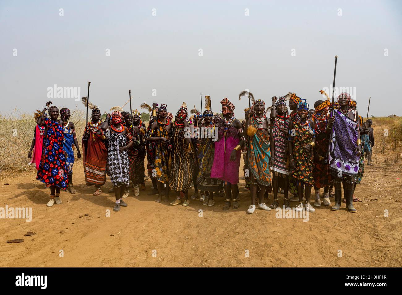 Traditional dressed women of the Jiye tribe dancing and singing ...