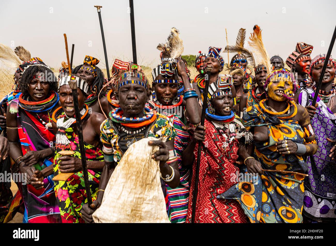 Traditional dressed women of the Jiye tribe dancing and singing ...